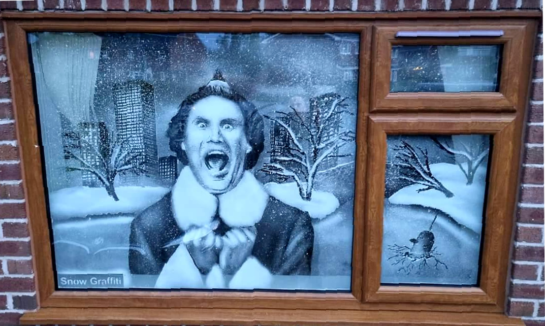Snow Graffiti Artist Creates Christmas Window Displays
